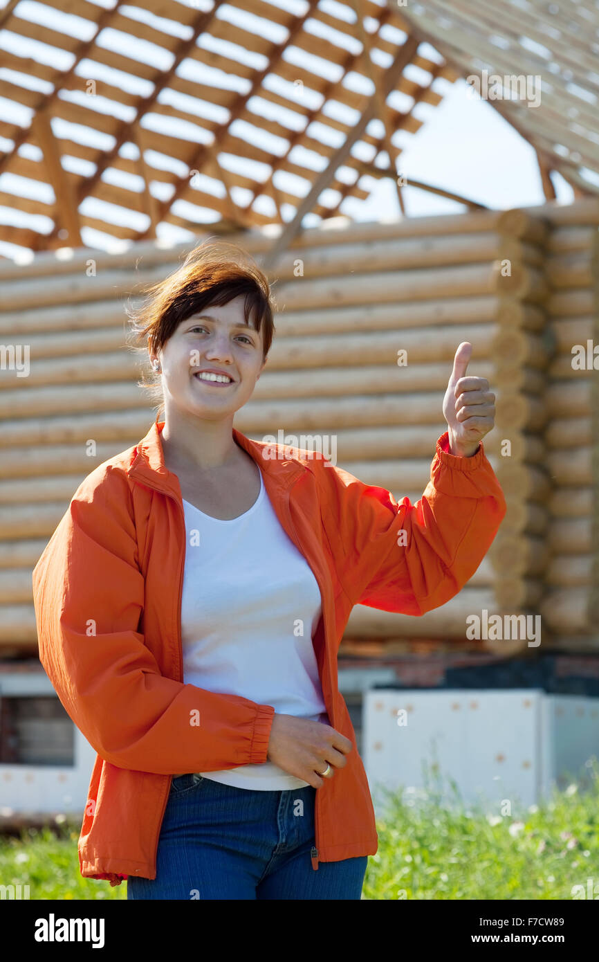 Happy young woman in front of building new home Stock Photo - Alamy