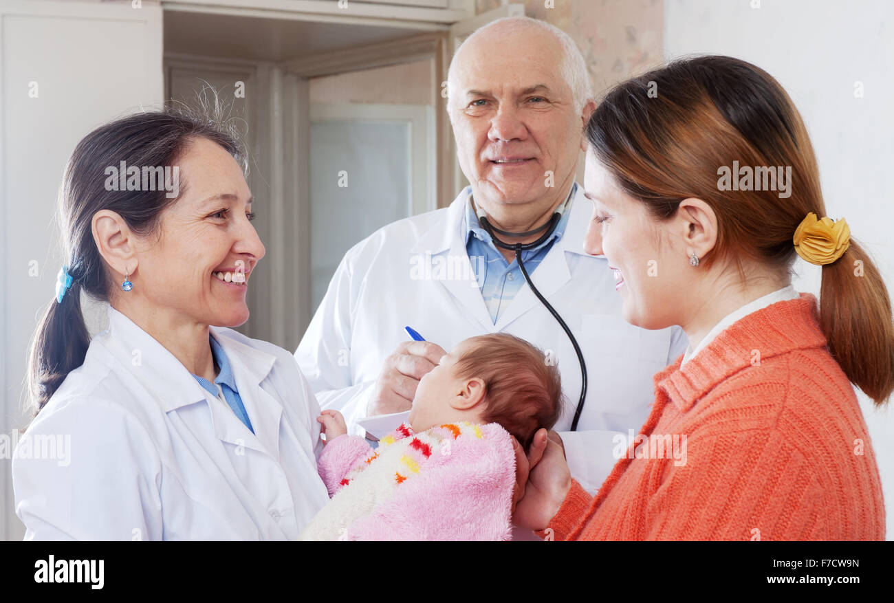 friendly doctor and nurse gives the healthy baby to happy mother Stock ...