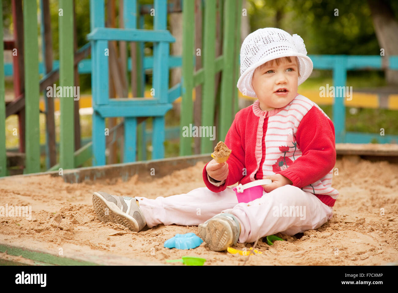 two-year child playing with sand in sandbox Stock Photo - Alamy