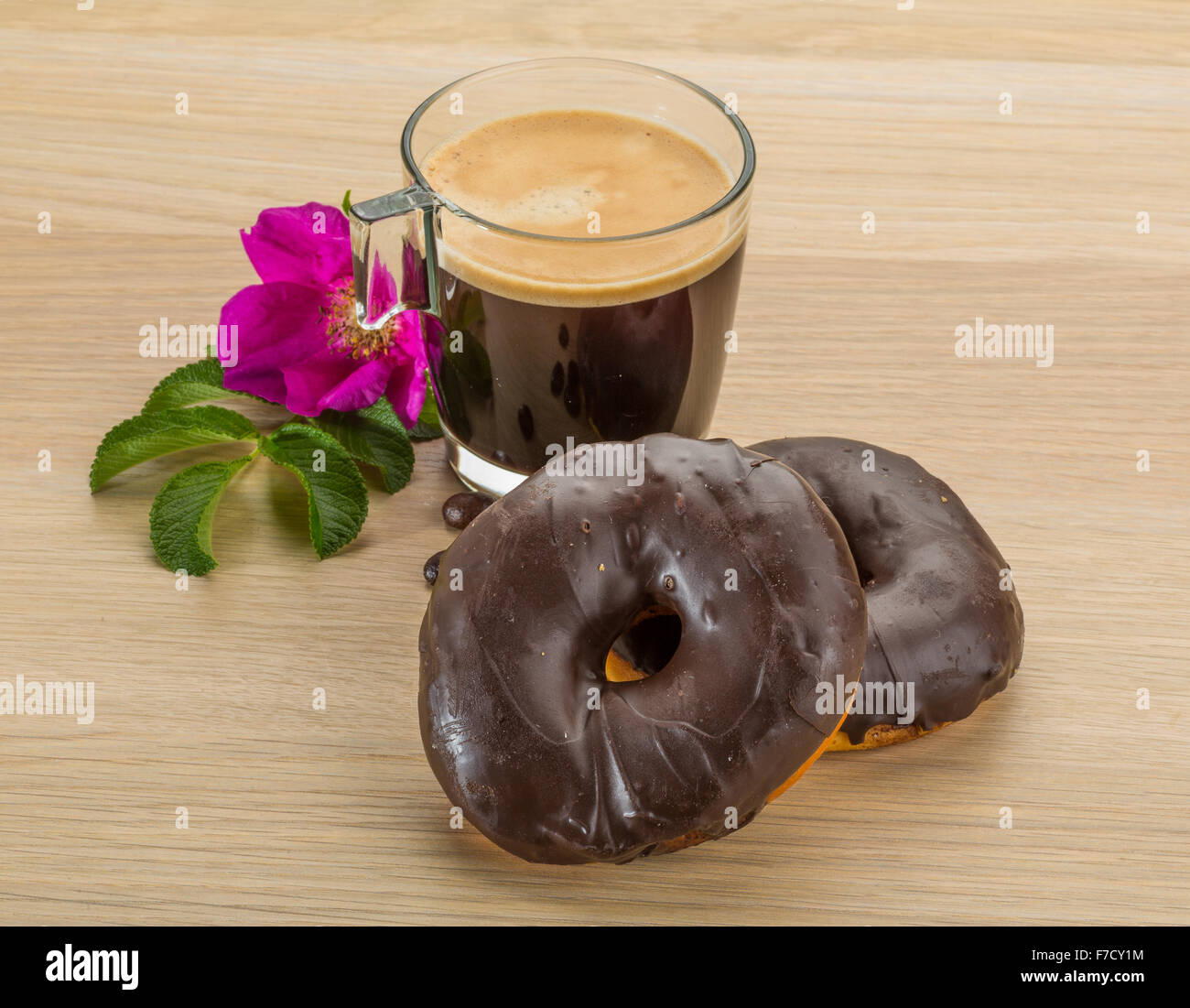Chocolate donuts with coffee on the desk Stock Photo - Alamy