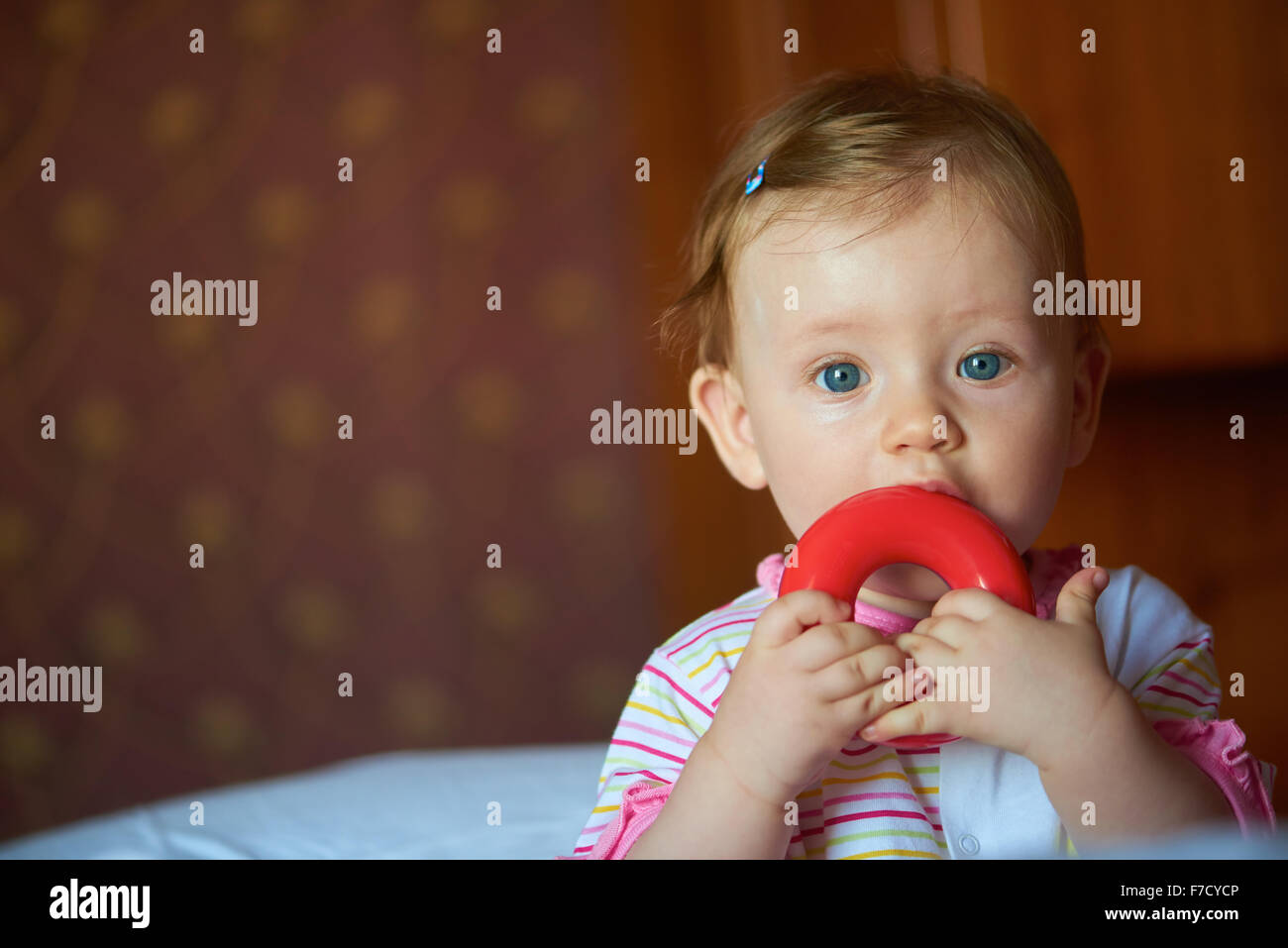 happy baby with first teeth smilling and play with toys Stock Photo - Alamy