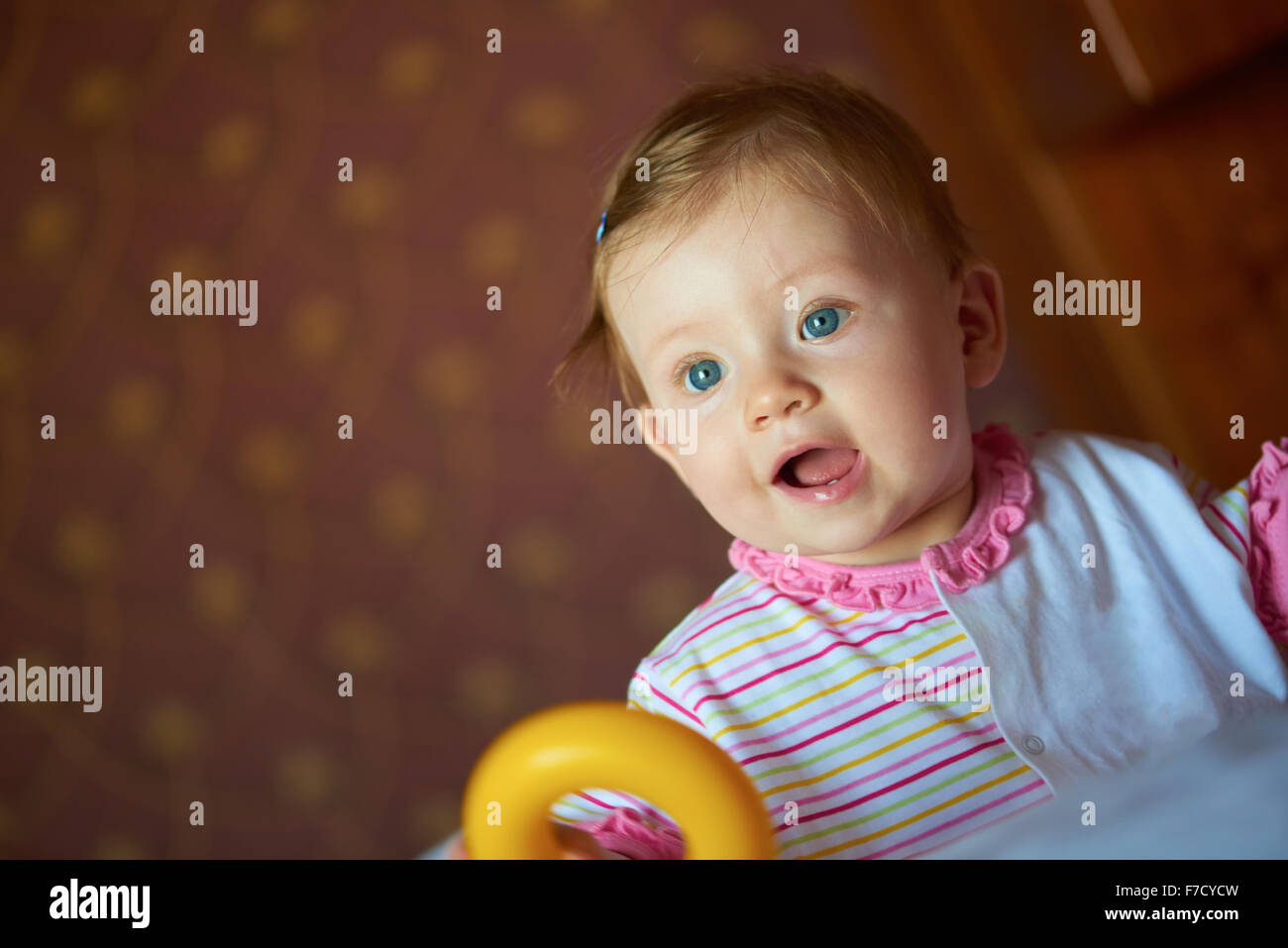 happy baby with first teeth smilling and play with toys Stock Photo - Alamy