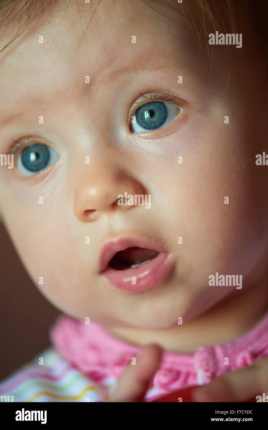 happy baby with first teeth smilling and play with toys Stock Photo - Alamy