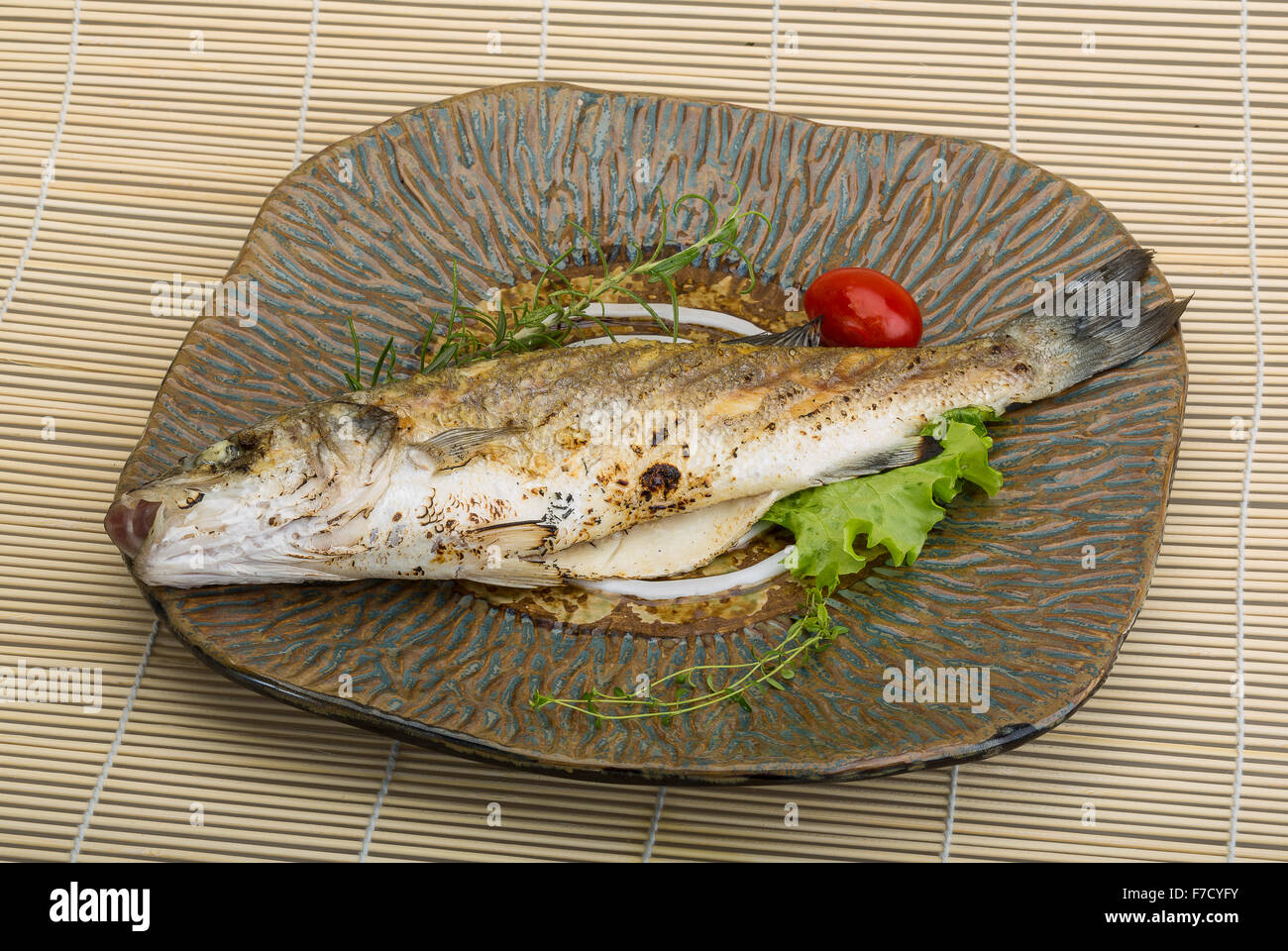 Grilled seabass fish - with rosemary and thyme Stock Photo - Alamy