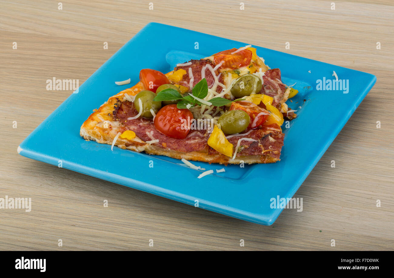 Salami pizza - on the blue table Stock Photo - Alamy