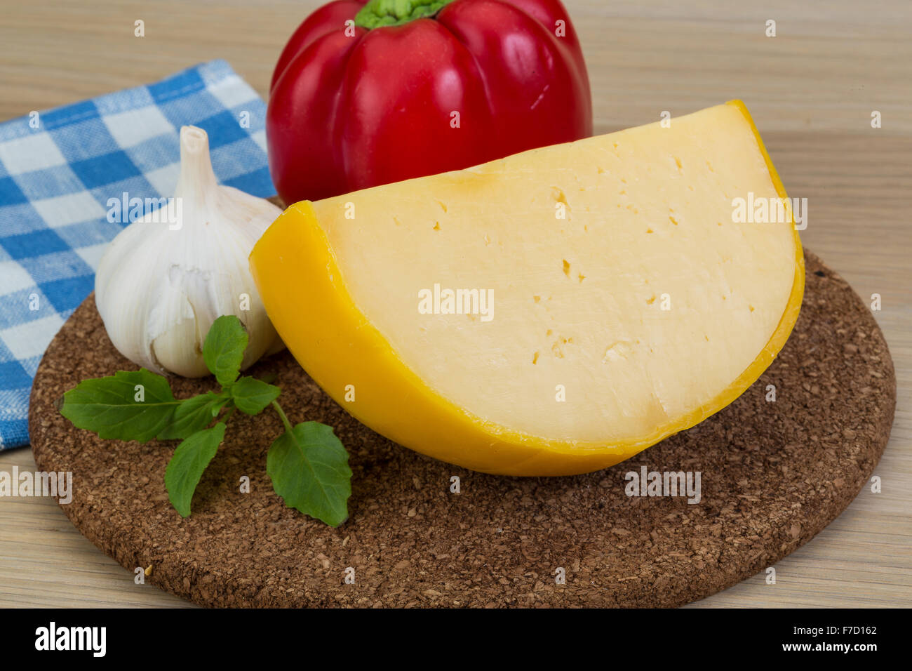 Yellow round cheese on the wood background Stock Photo - Alamy