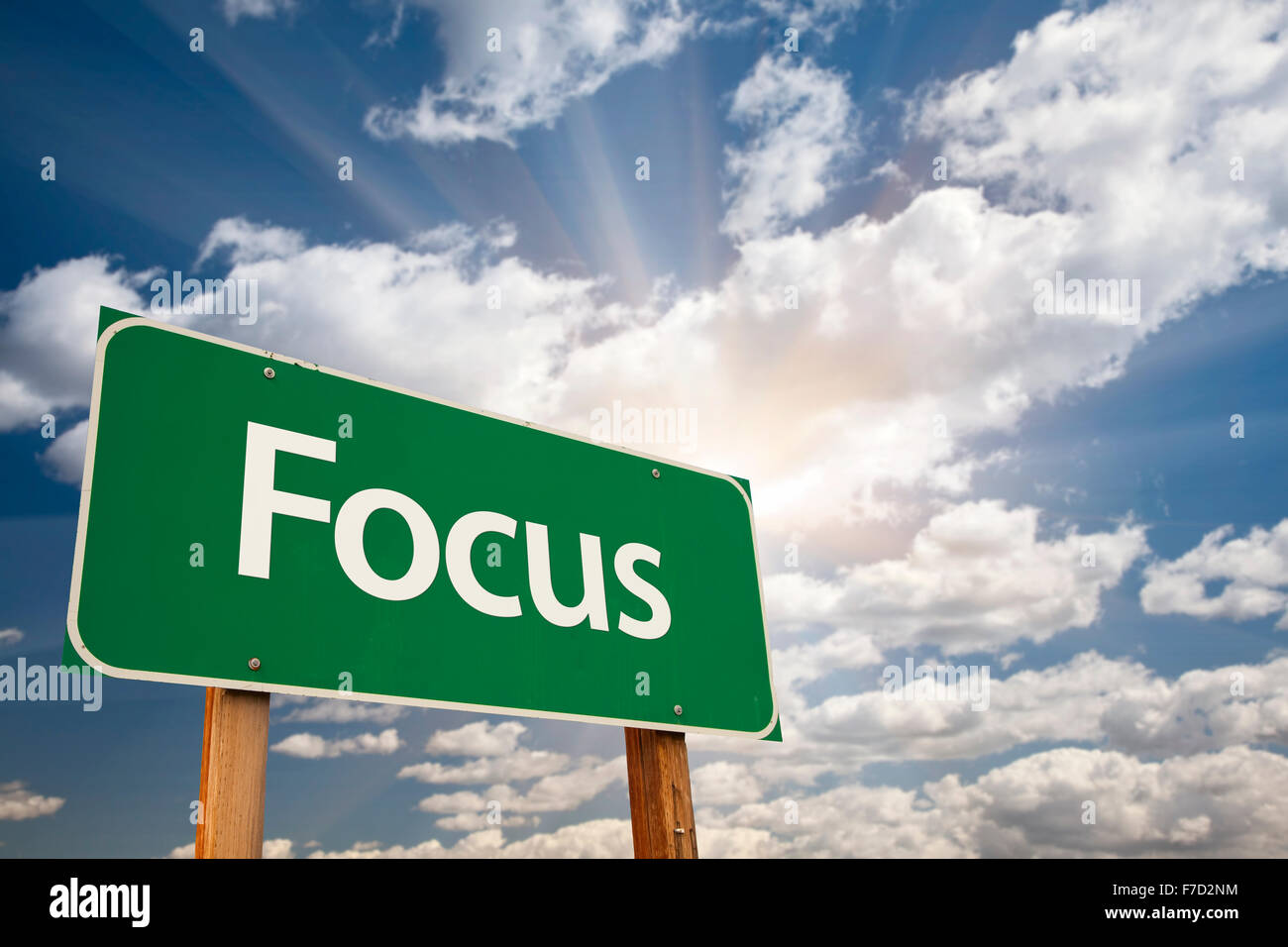 Focus Green Road Sign with Dramatic Clouds and Sky Stock Photo - Alamy