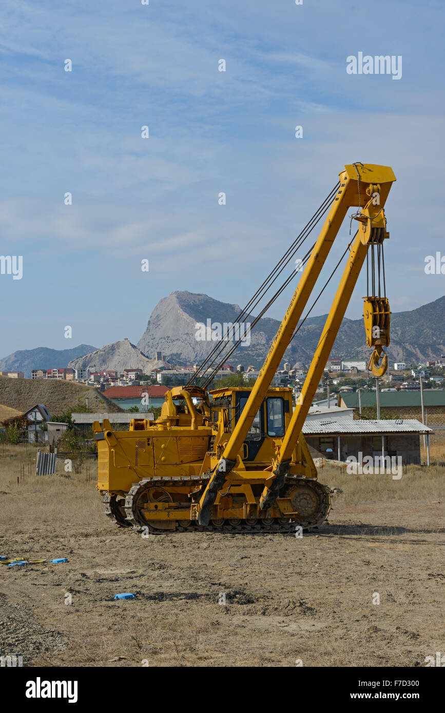Yellow pipe layer dozer is at pipeline building place on background of ...