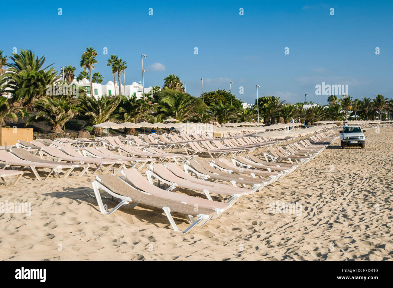 Sunloungers on an empty beach at a Spanish tourist resort Stock Photo ...