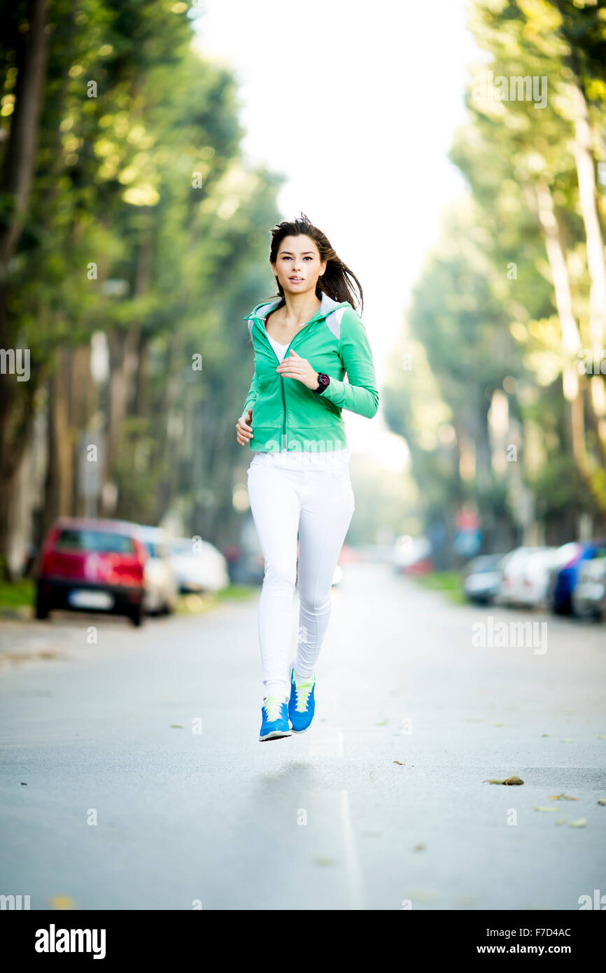 Young woman running in the park Stock Photo - Alamy