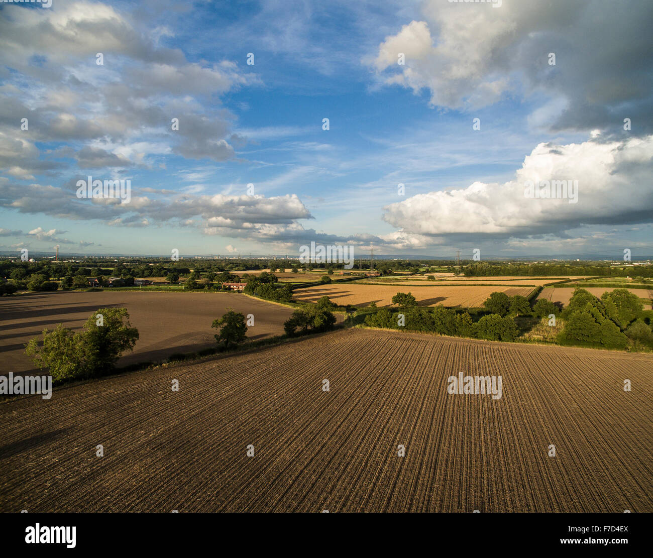 Aerial view of patchwork quilt fields, horizon and dramatic clouds and ...