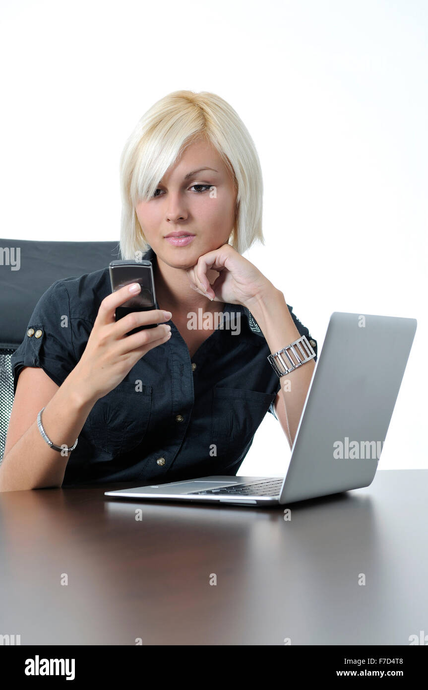 One young business blonde woman working in office on laptop and talking ...