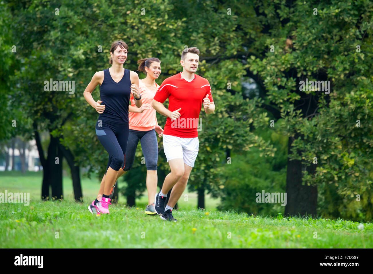 Young people running in the park Stock Photo - Alamy