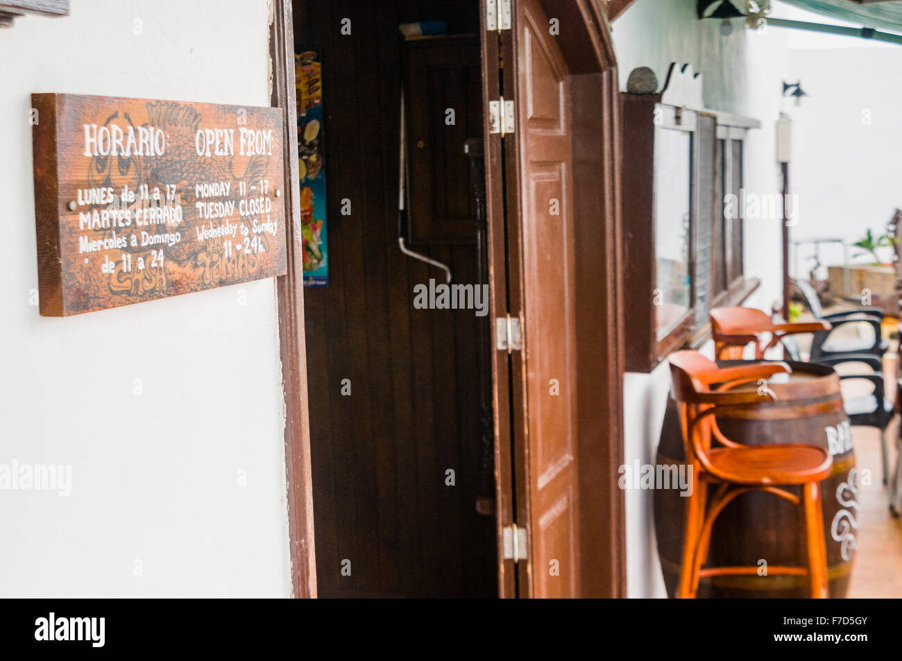 Sign outside the door of a Spanish bar with opening hours Stock Photo ...