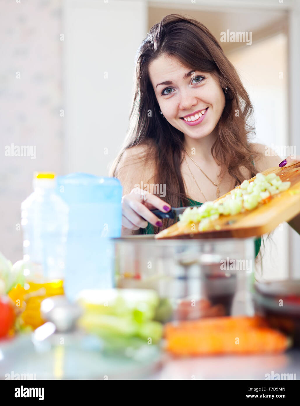 Happy woman cooking dinner at home Stock Photo - Alamy