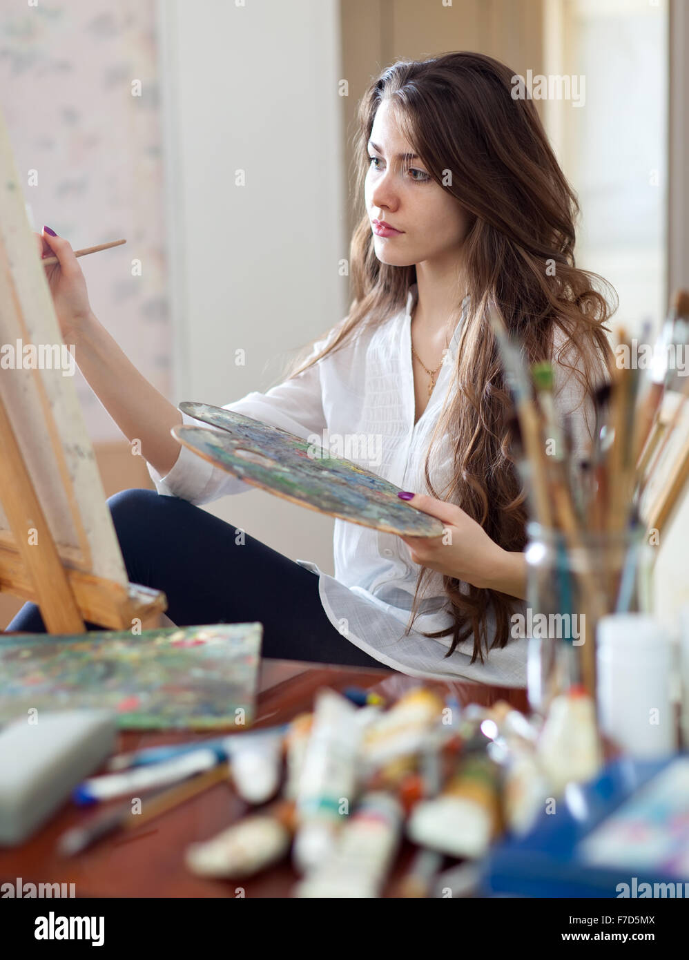 artist paints picture on canvas with oil paints in her workshop Stock Photo - Alamy
