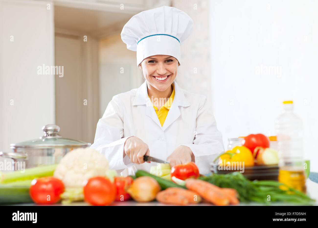 Happy cook prepares vegetarian lunch at commercial kitchen Stock Photo ...
