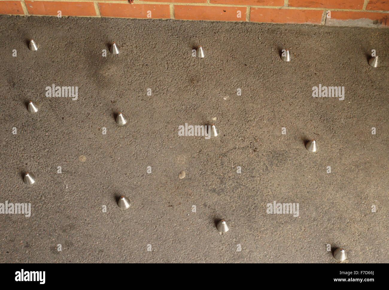 Anti-Homeless spikes installed next to the entrance to a block of ...