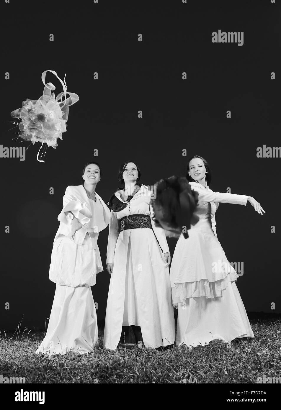 group of bride run on meadow at sunset after wedding party Stock Photo ...