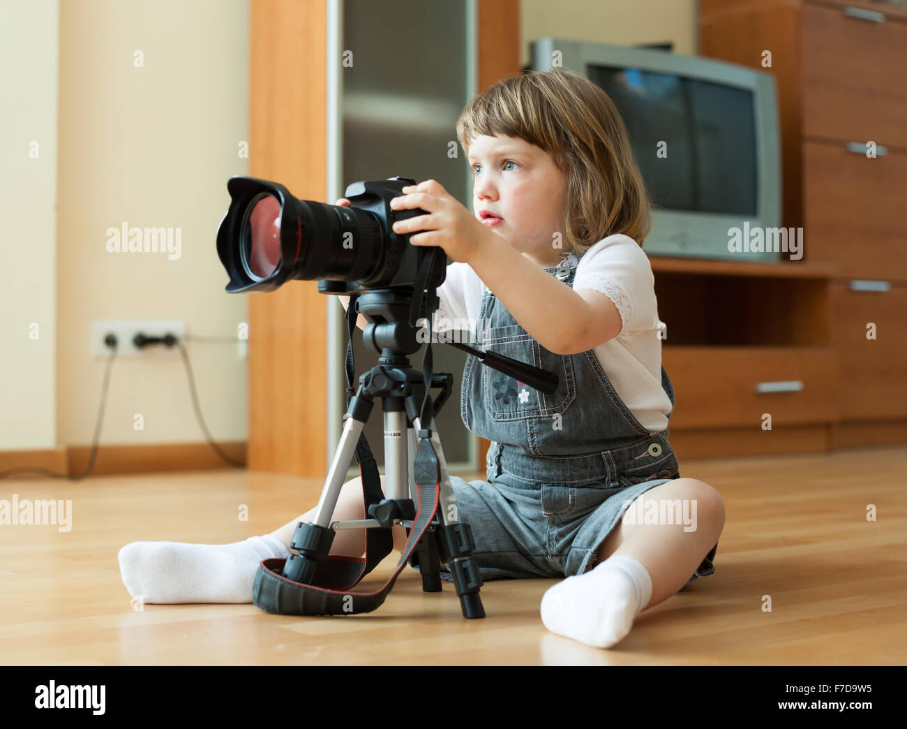 two-year baby girl takes photo with camera in home Stock Photo - Alamy