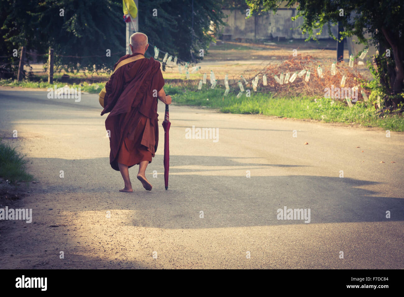 Monk walks down the street to the temple Stock Photo - Alamy