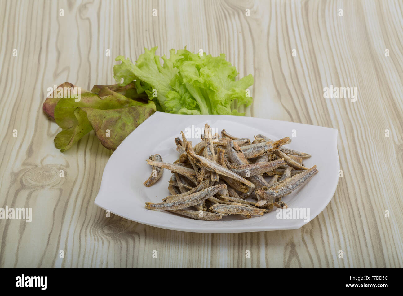 Dries anchovy - small fishes in the bowl Stock Photo - Alamy