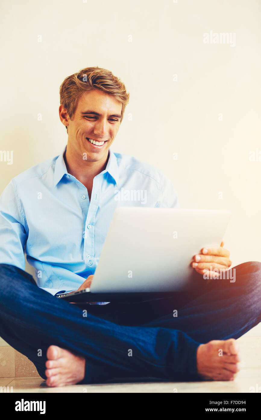 Young Man Using Laptop Working from Home Stock Photo - Alamy