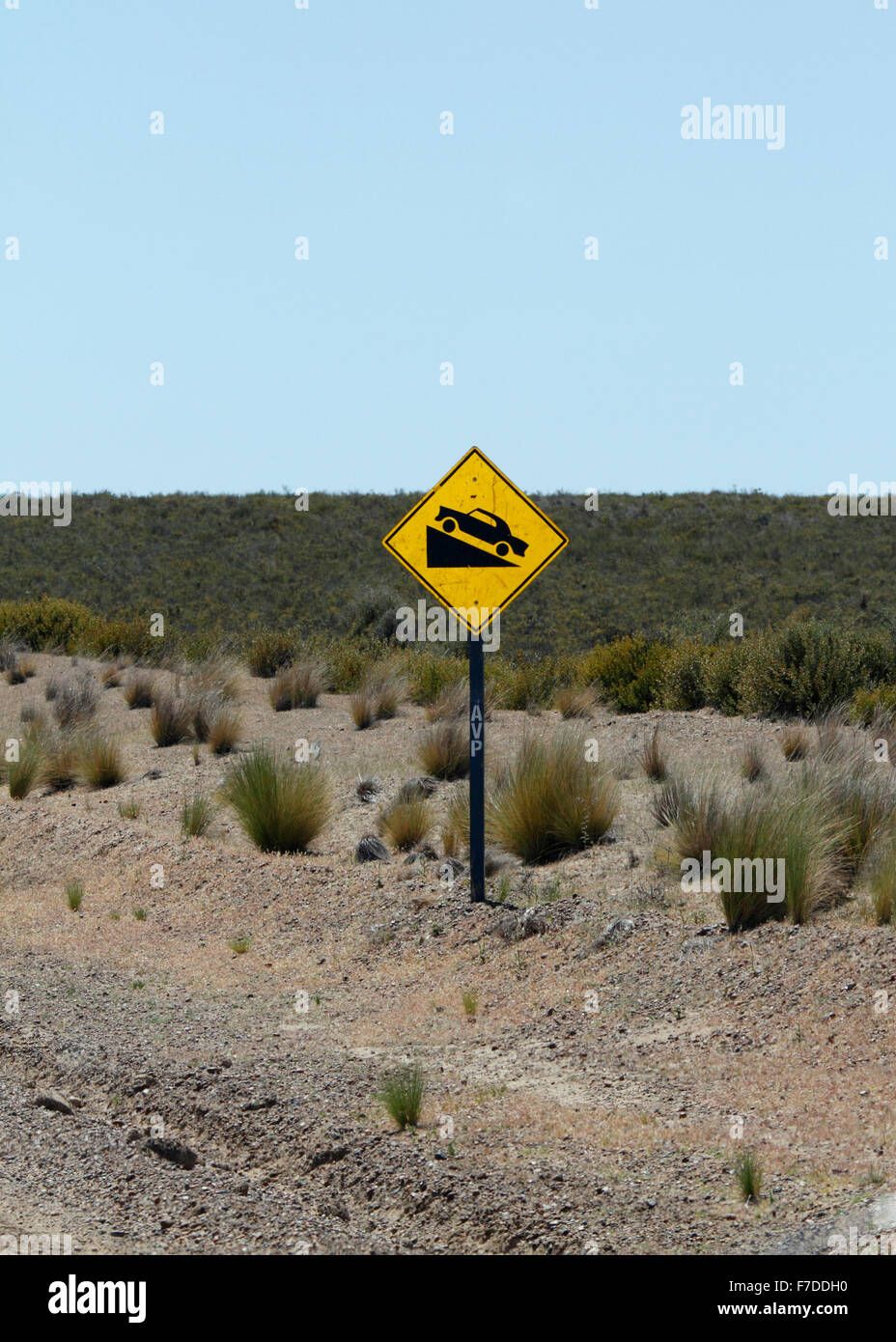 Gradient sign on a yellow diamond shaped sign. Car climbing a hill ...