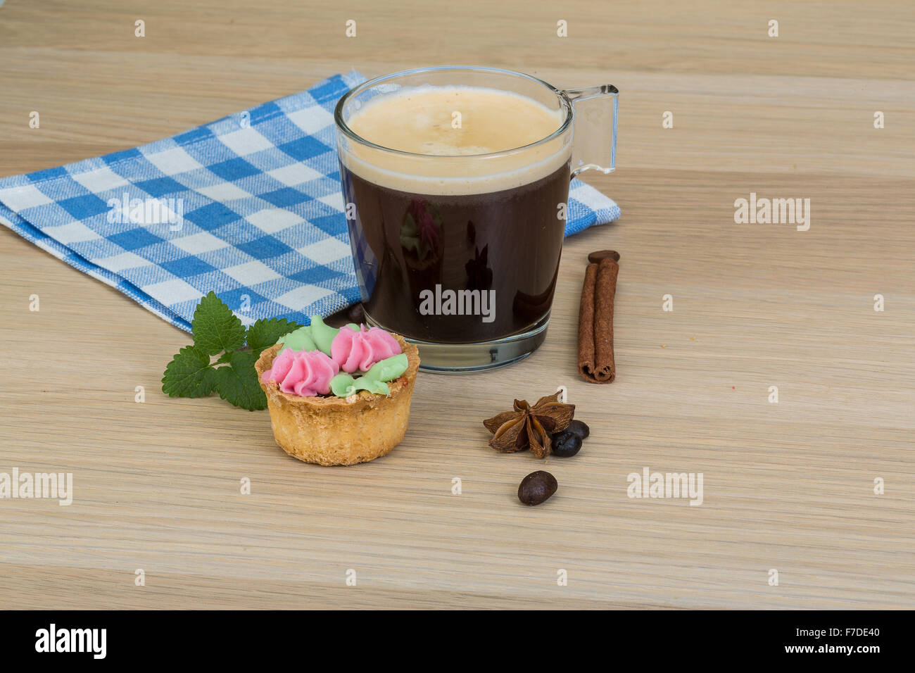 Coffee with sweet pastry and beans, cinnamon Stock Photo - Alamy