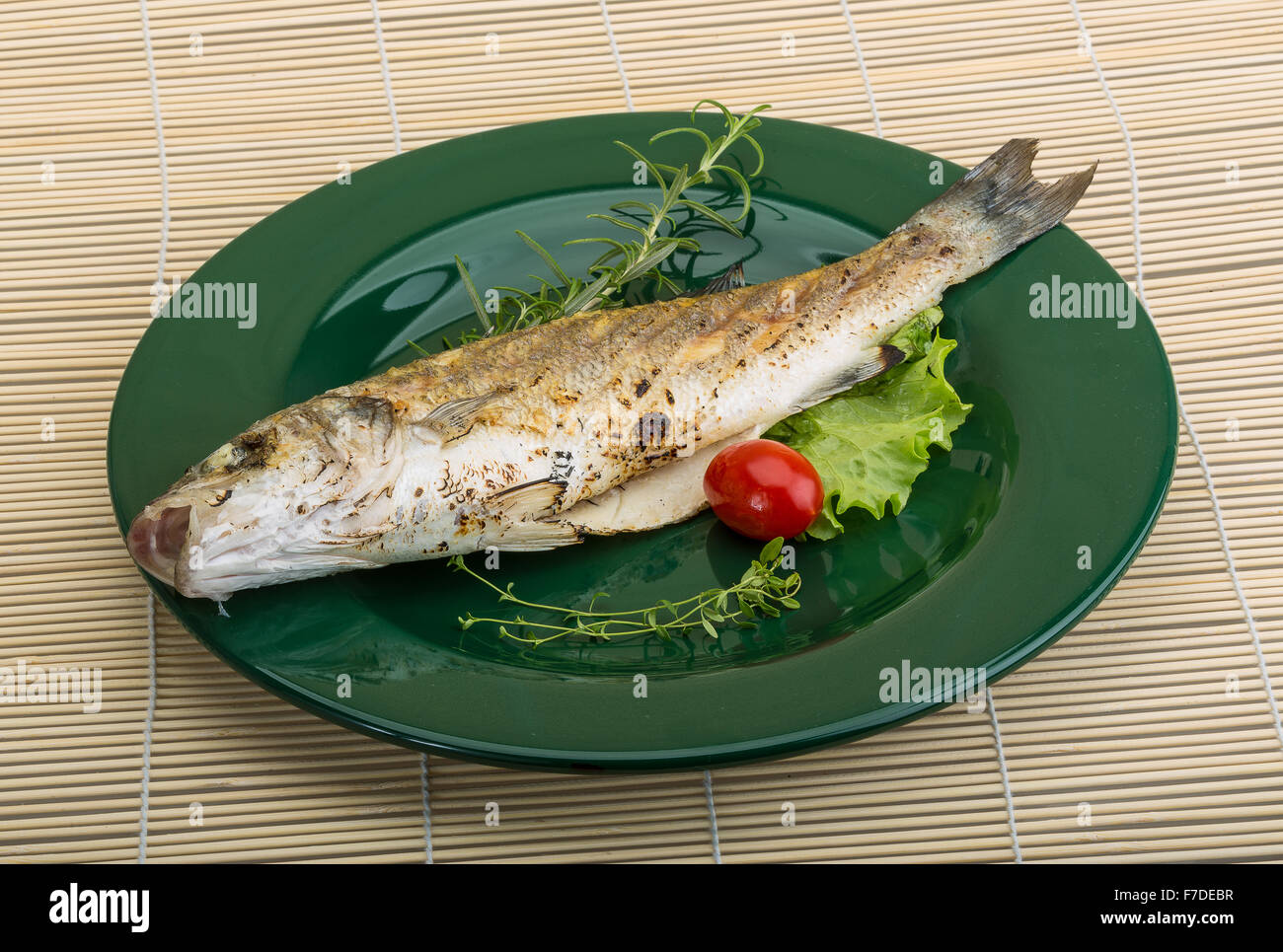 Grilled seabass fish - with rosemary and thyme Stock Photo - Alamy