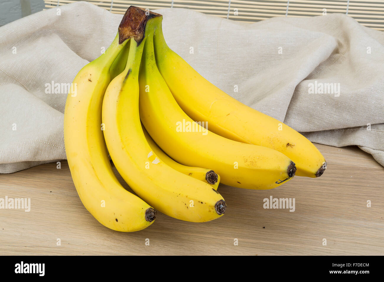 Ripe Banana branch on the wooden background Stock Photo - Alamy
