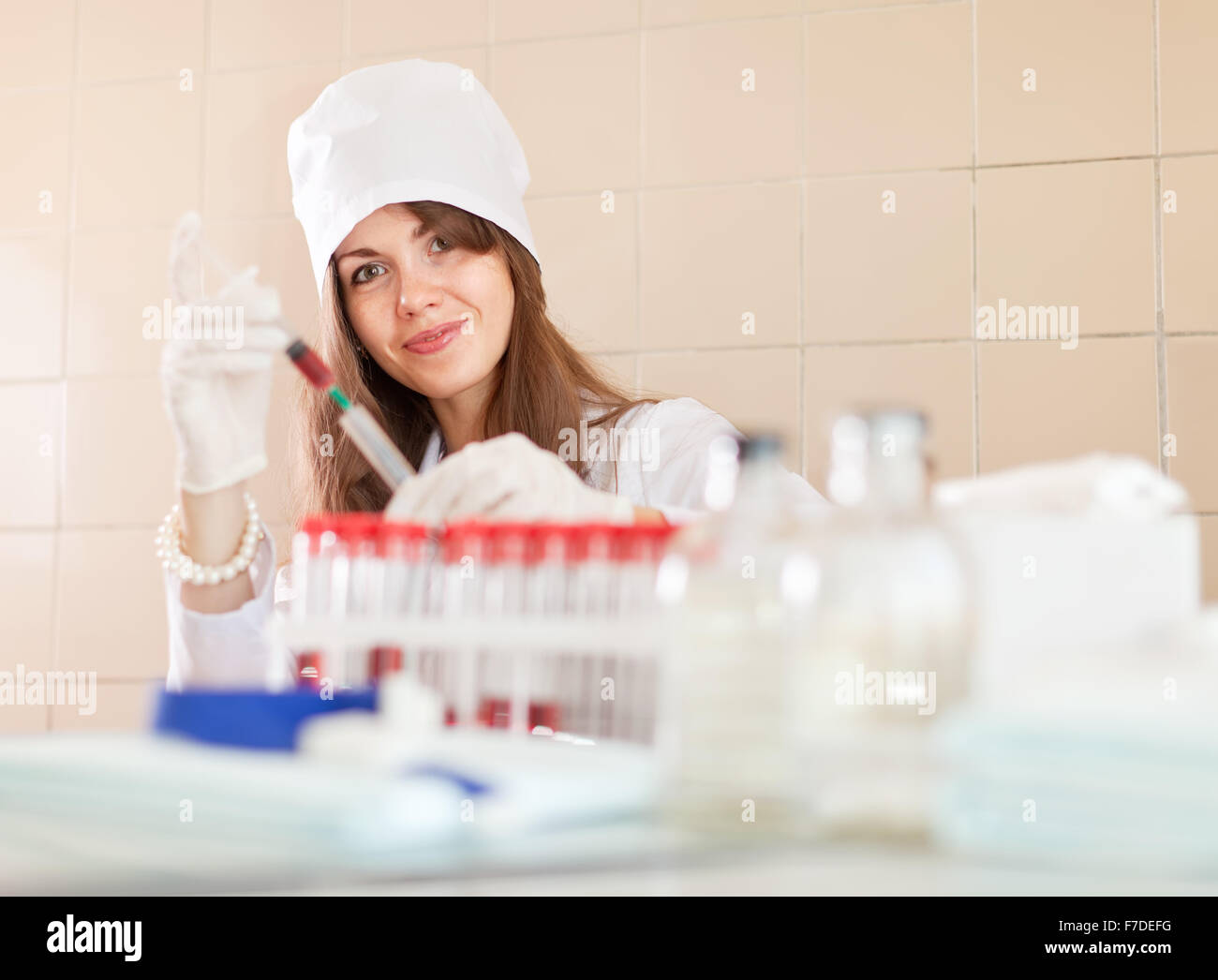 Positive nurse with test tubes in laboratory Stock Photo - Alamy