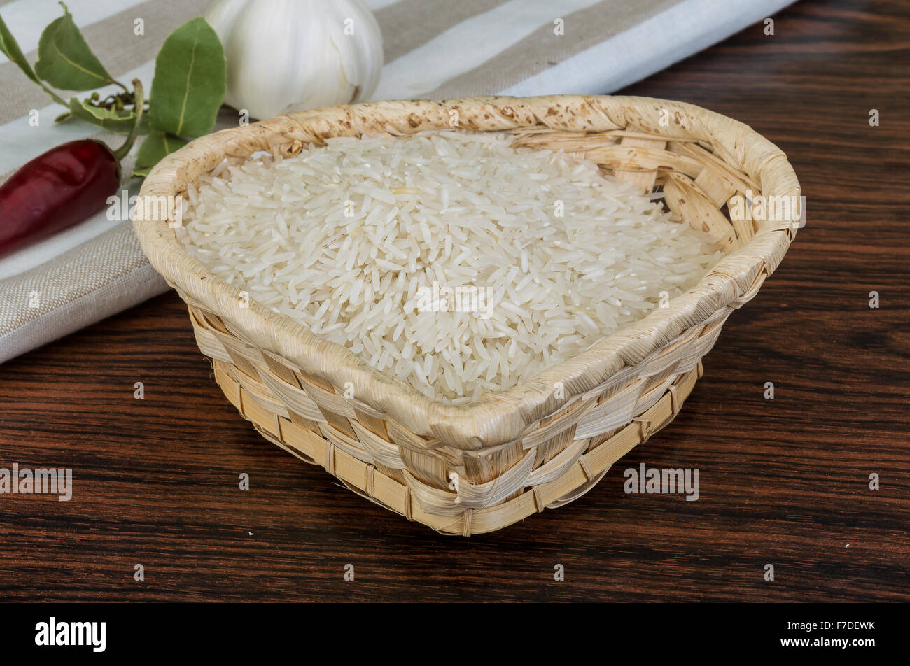 Raw Basmati rice in the bowl on wooden background Stock Photo - Alamy