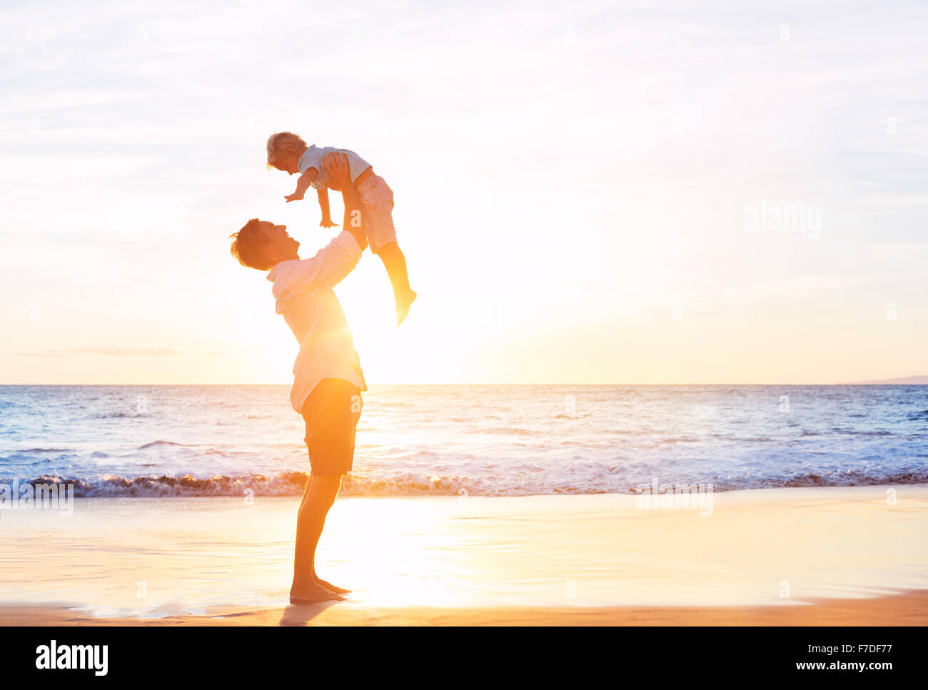Happy Joyful Father and Son Having Fun Playing on the Beach at Sunset ...