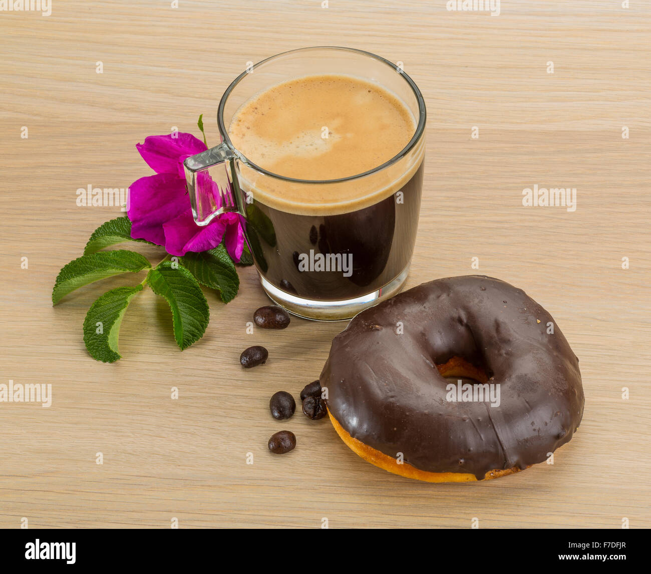 Chocolate donuts with coffee on the desk Stock Photo - Alamy