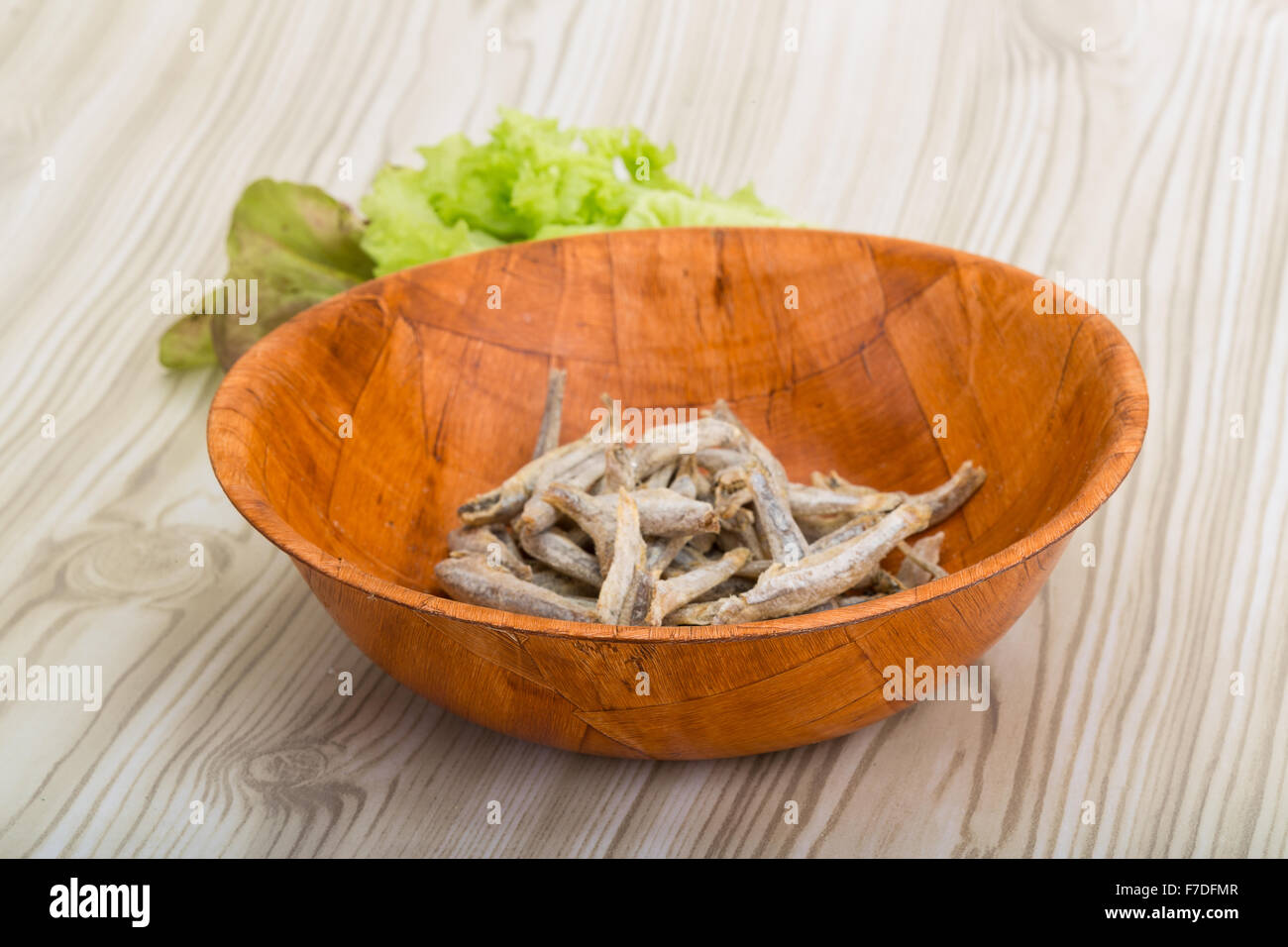 Dries anchovy - small fishes in the bowl Stock Photo - Alamy