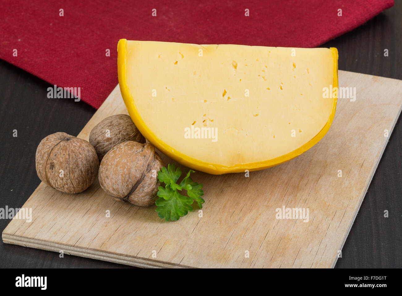 Yellow round cheese on the wood background Stock Photo - Alamy