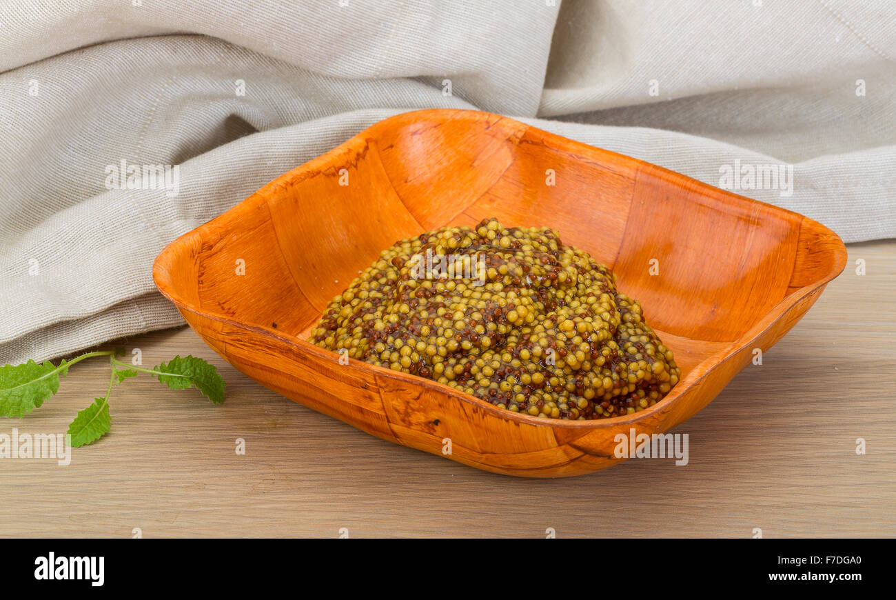 French mustard with fresh leaves on wooden background Stock Photo - Alamy