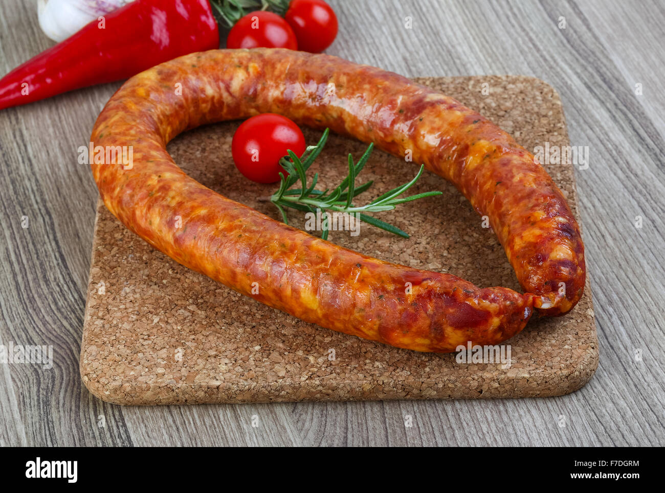 Sausage ring with rosemary and pepper on the wood background Stock ...