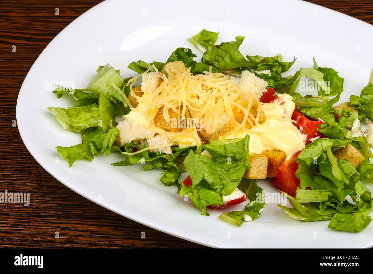 Caesar salad with chicken on the wood background Stock Photo - Alamy