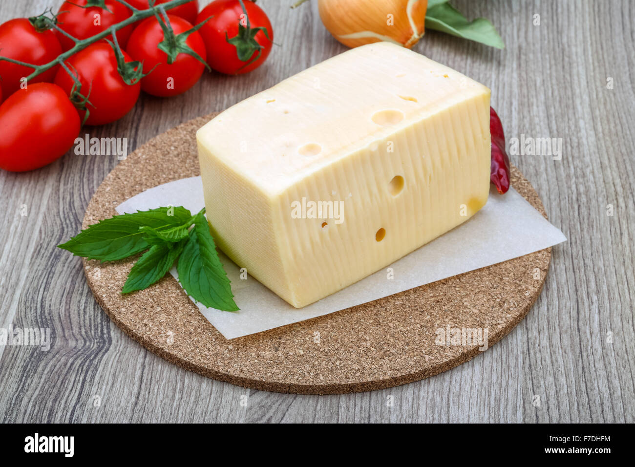 Yellow cheese brick with mint leaves on the wood background Stock Photo ...