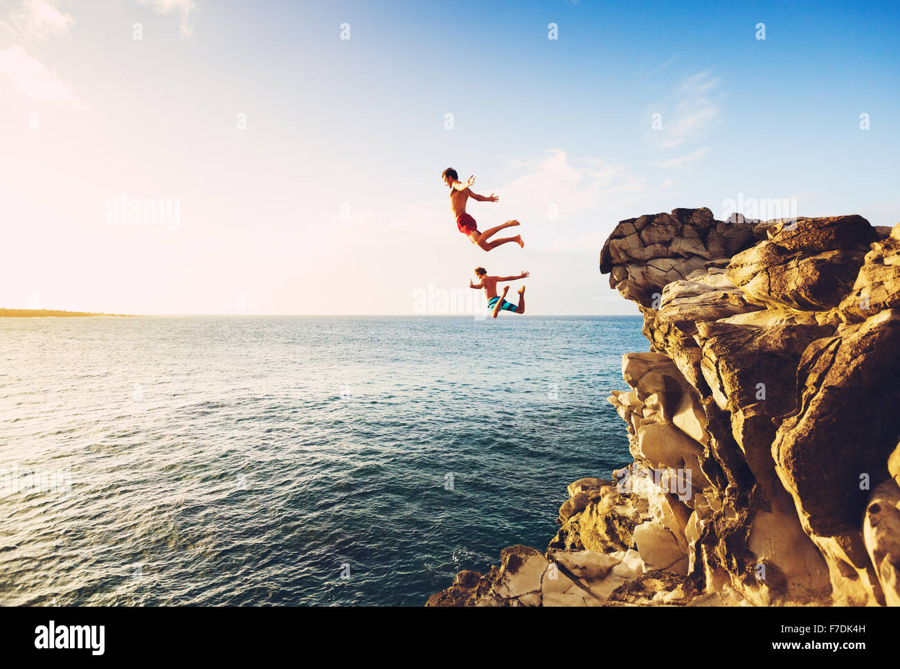 Friends Cliff Jumping into the Ocean at Sunset, Outdoor Adventure ...