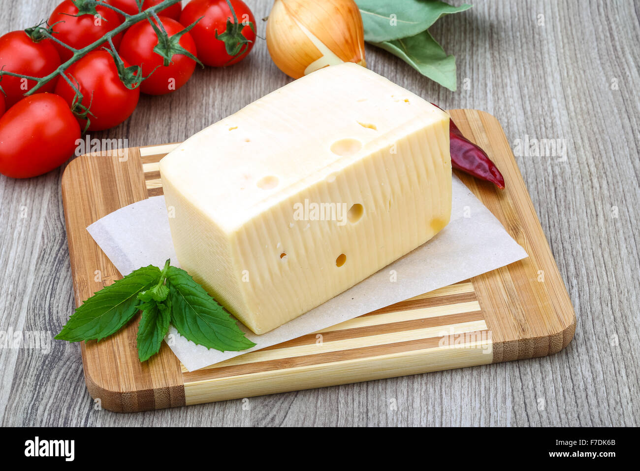 Cheese brick with mint leaves on the wood background Stock Photo - Alamy