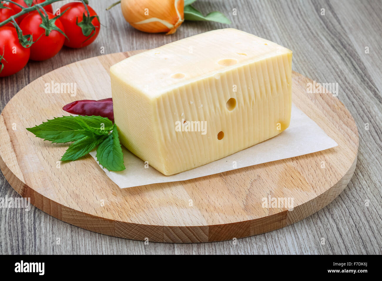 Yellow cheese brick with mint leaves on the wood background Stock Photo ...