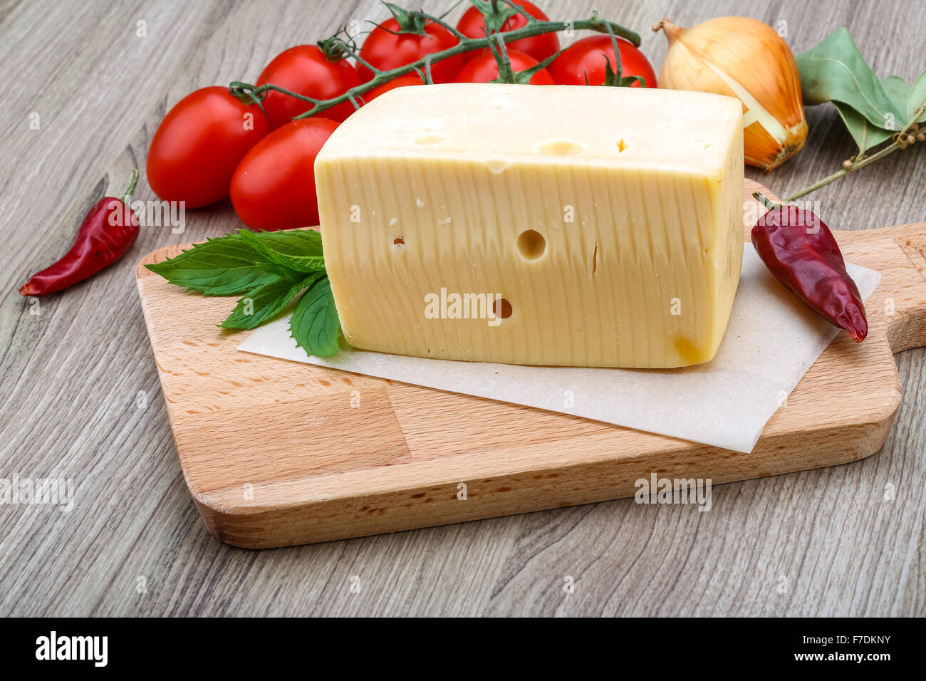 Yellow cheese brick with mint leaves on the wood background Stock Photo ...