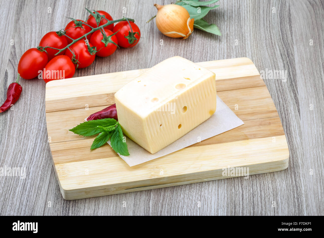 Yellow cheese brick with mint leaves on the wood background Stock Photo ...