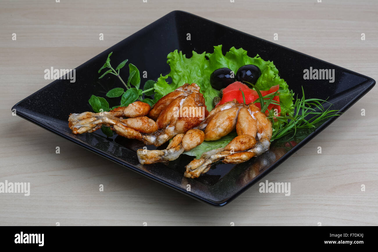 Roasted Frog legs with herbs and spices Stock Photo - Alamy