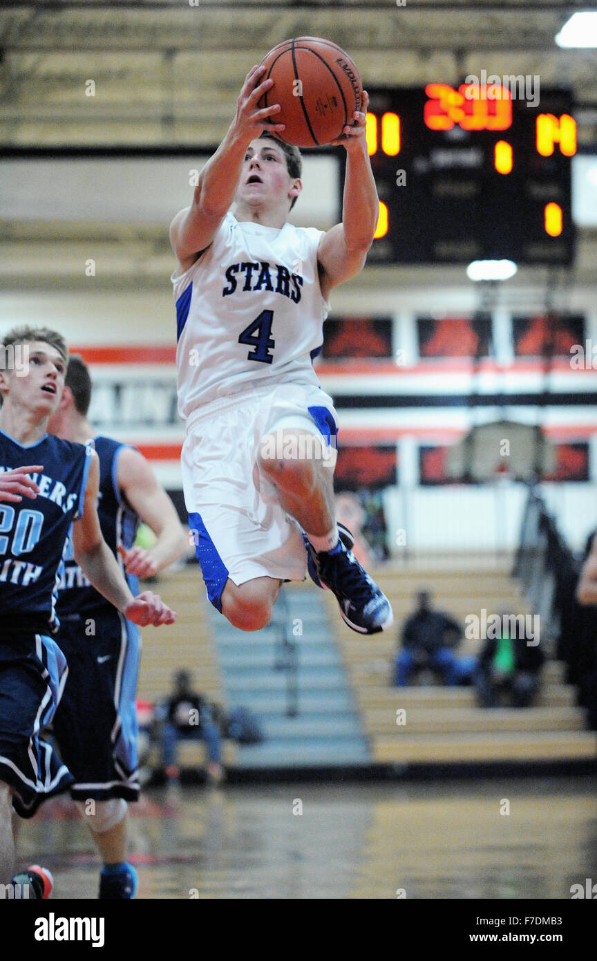 Player finishes off an airborne drive to the hoop against during a high ...