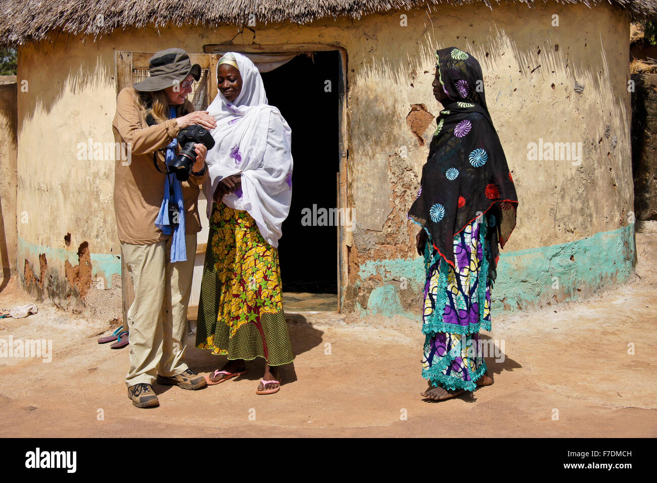 Tourist with women of Dagomba tribe in traditional dress, Mbanayili ...