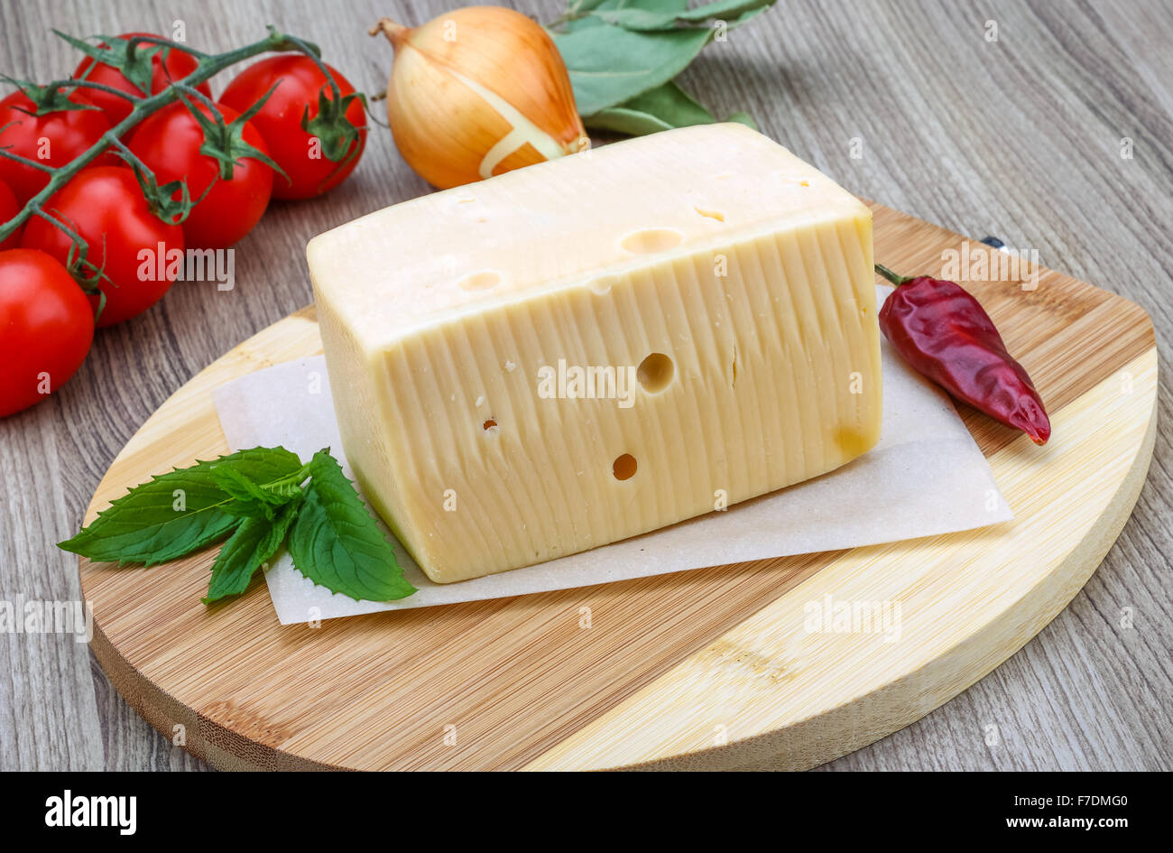 Yellow cheese brick with mint leaves on the wood background Stock Photo ...